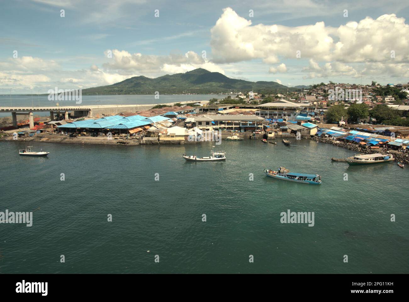 Boats, coastal water and part of the coastal landscape of Manado City ...