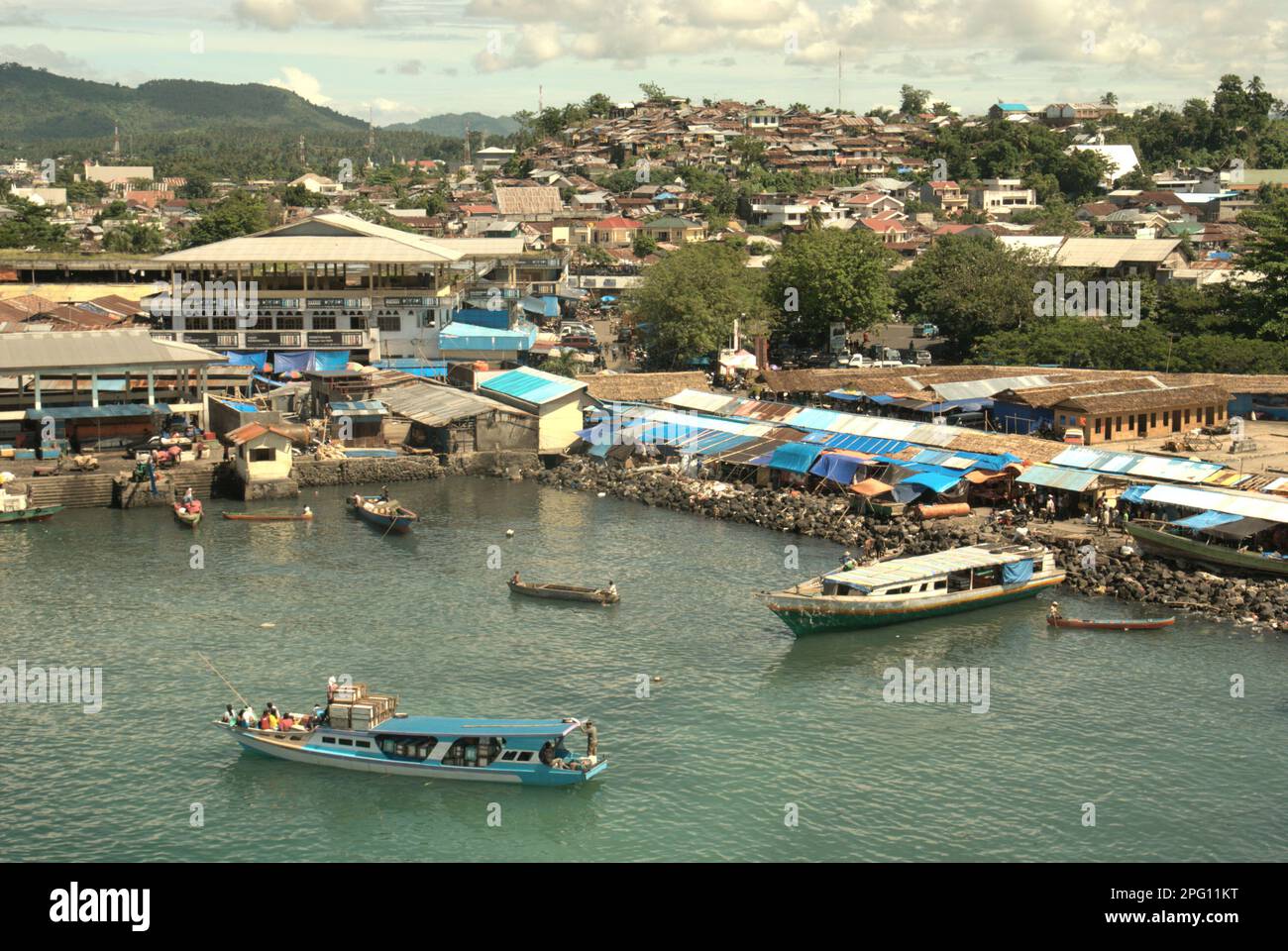 Boats, coastal water and part of the coastal landscape of Manado City ...