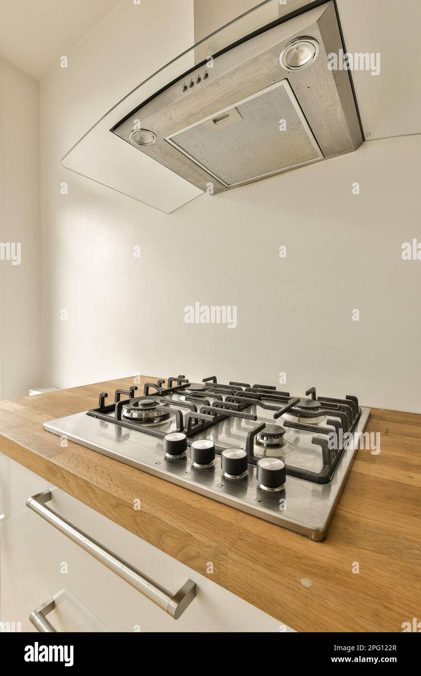 a kitchen with wood counter tops and stove hood over the range in this ...