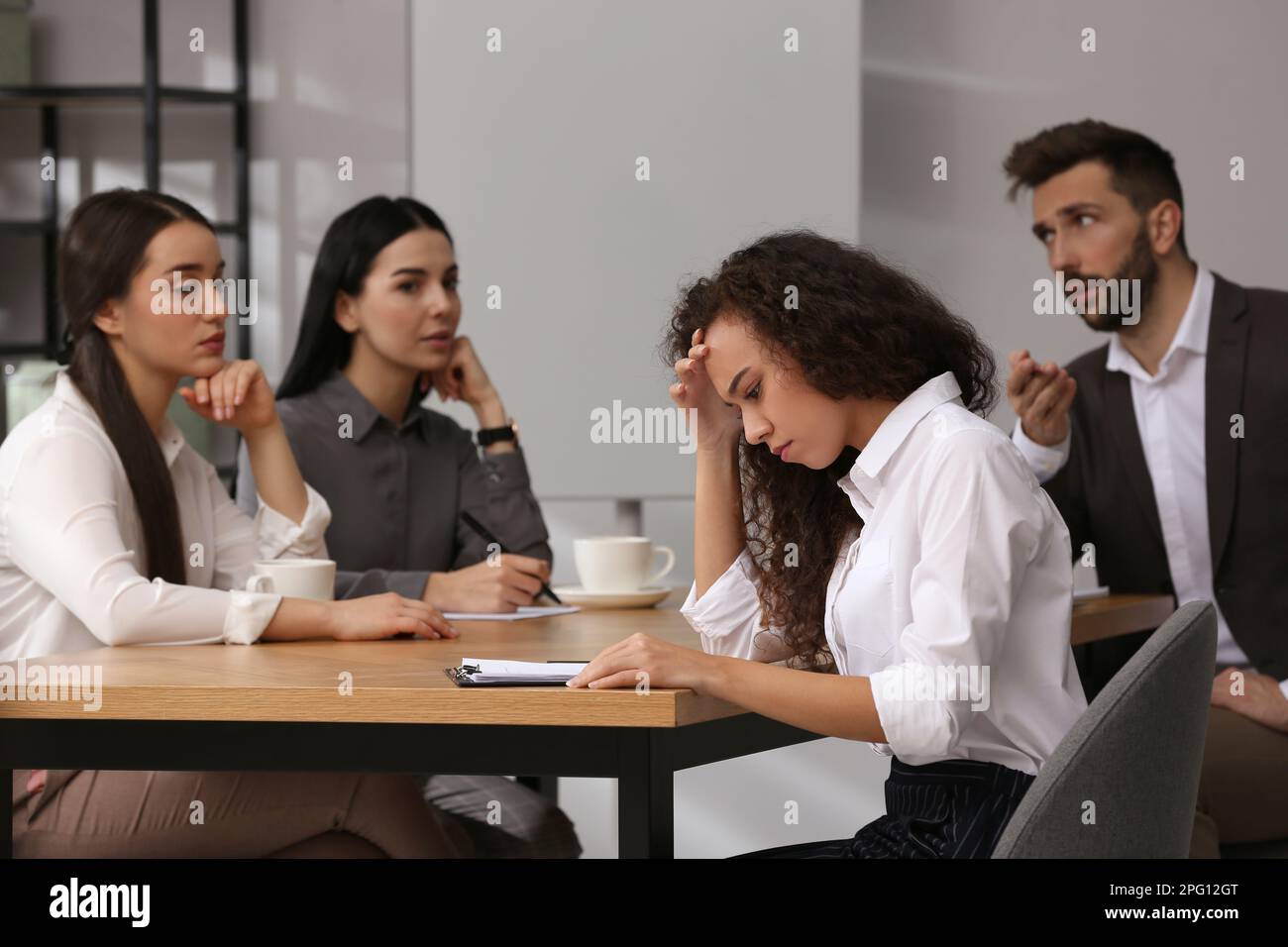 African American woman suffering from racial discrimination at work ...