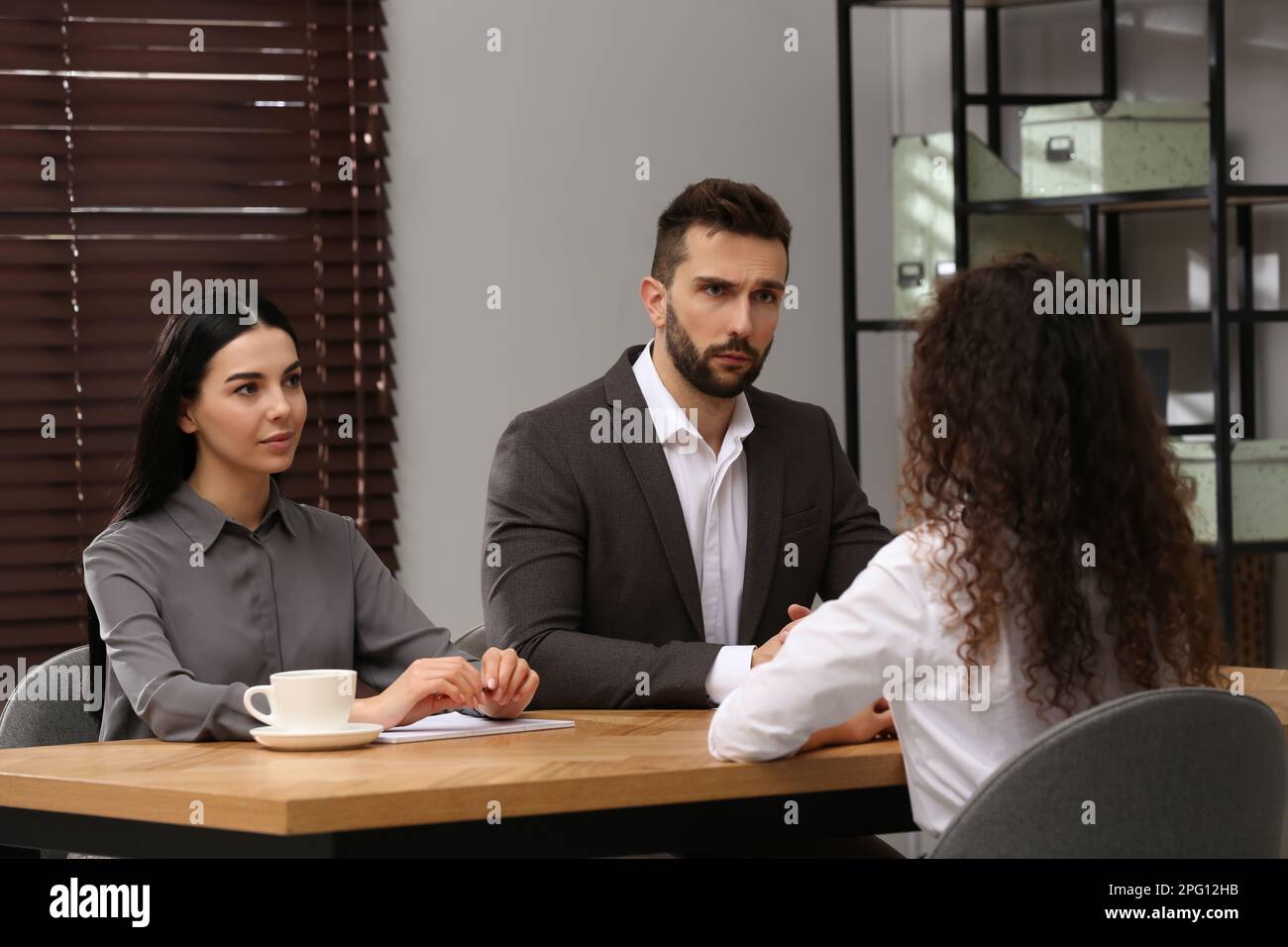 Coworkers conducting job interview with African American woman in ...