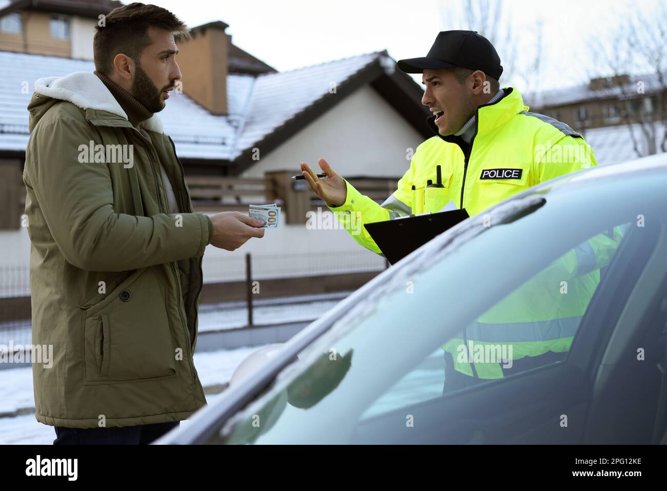 Man giving bribe to police officer near car outdoors Stock Photo - Alamy
