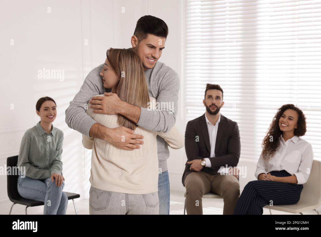 Psychotherapist working with patient at group session indoors Stock ...