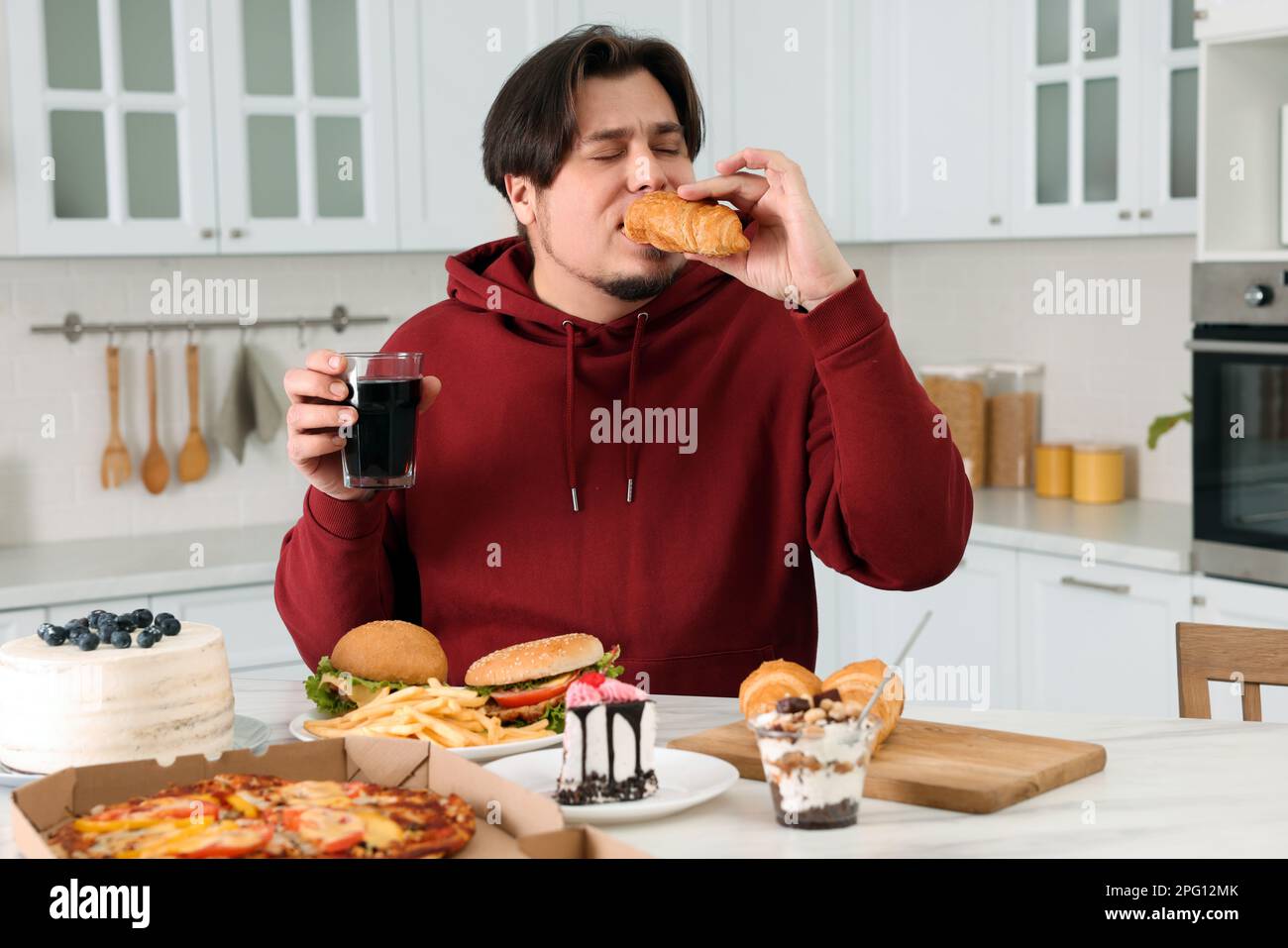 Overweight man eating tasty hi-res stock photography and images - Alamy