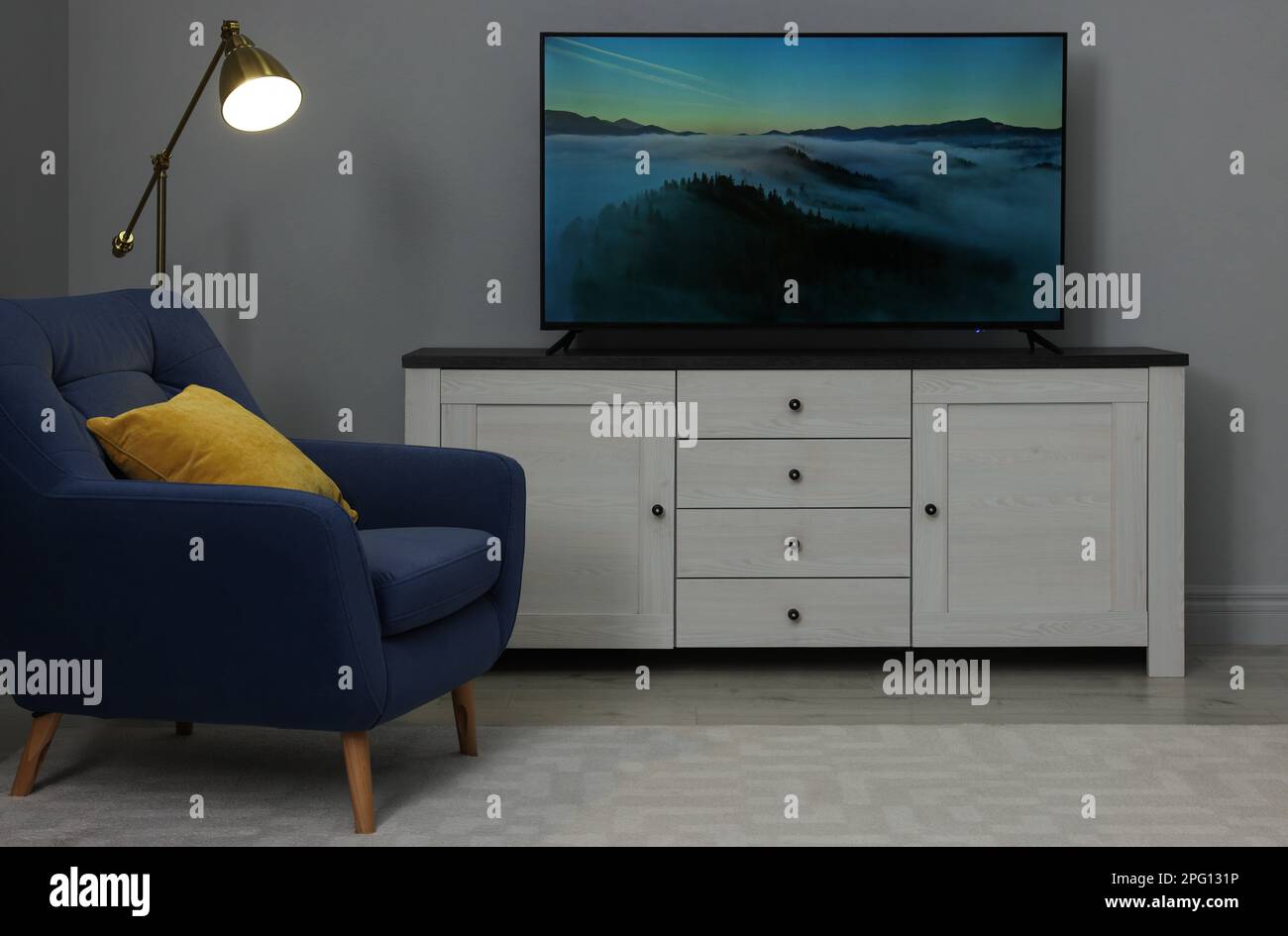 Cozy room interior with stylish comfortable armchair and TV set Stock ...