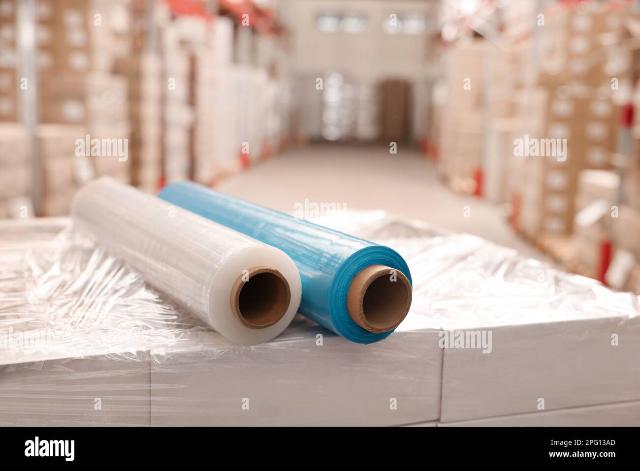 Rolls of different stretch wraps on boxes in warehouse Stock Photo - Alamy