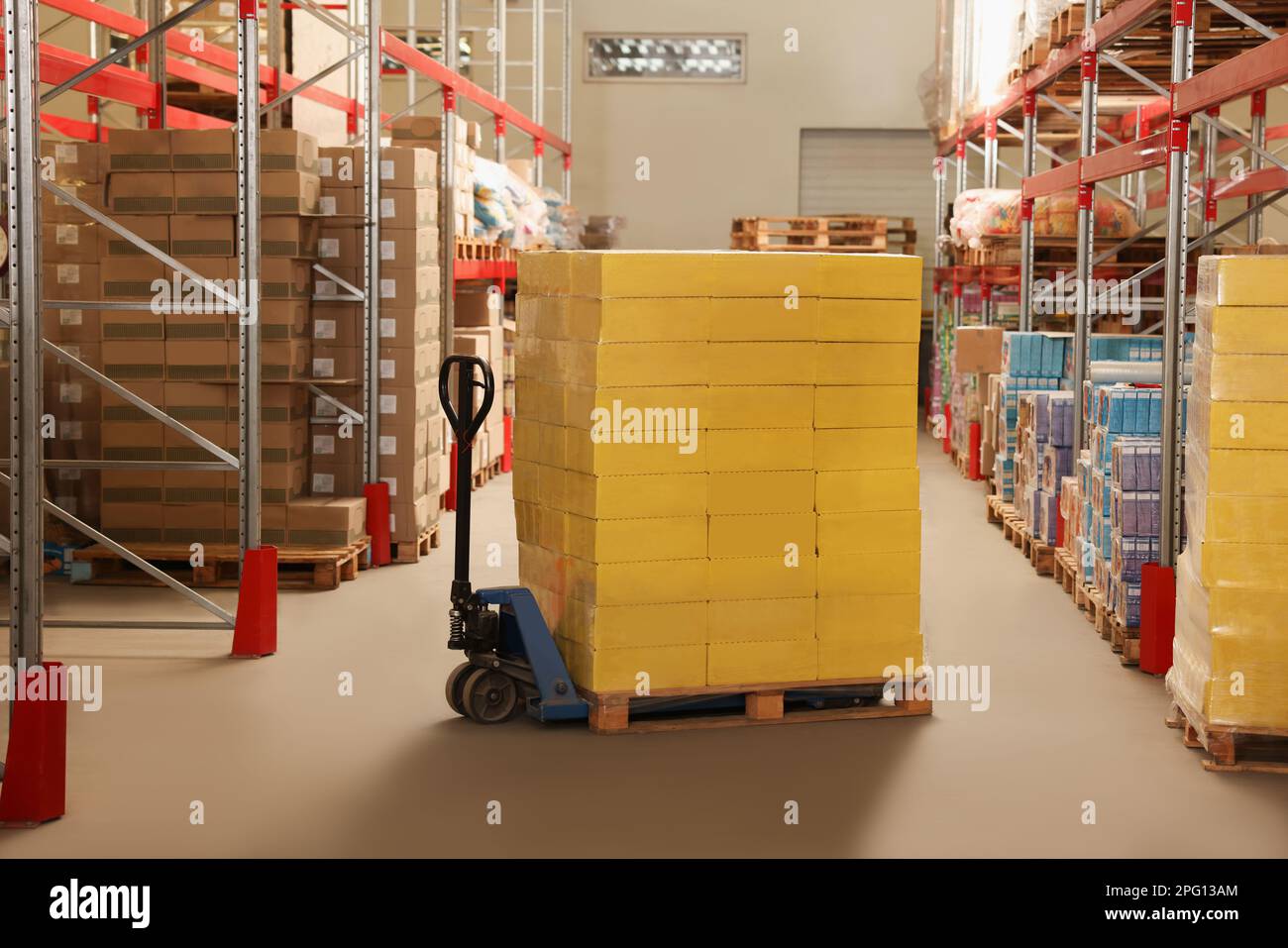 Manual pallet truck with stacked boxes in warehouse. Wholesaling Stock ...