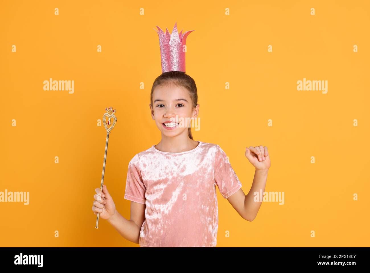 Cute girl in pink crown with magic wand on yellow background. Little ...