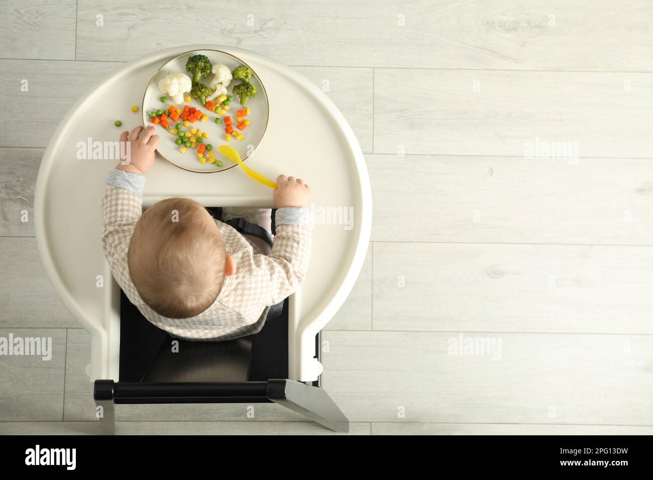 Cute little baby eating healthy food, top view. Space for text Stock ...