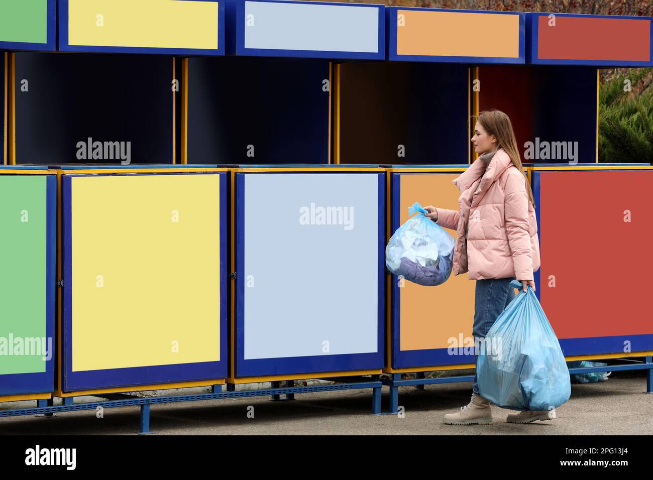 Woman throwing garbage at recycling point outdoors Stock Photo - Alamy