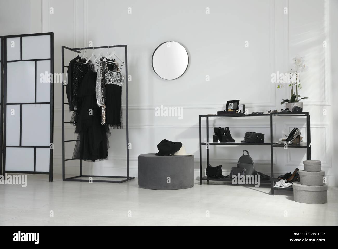 Stylish dressing room interior with trendy clothes, shoes and ...