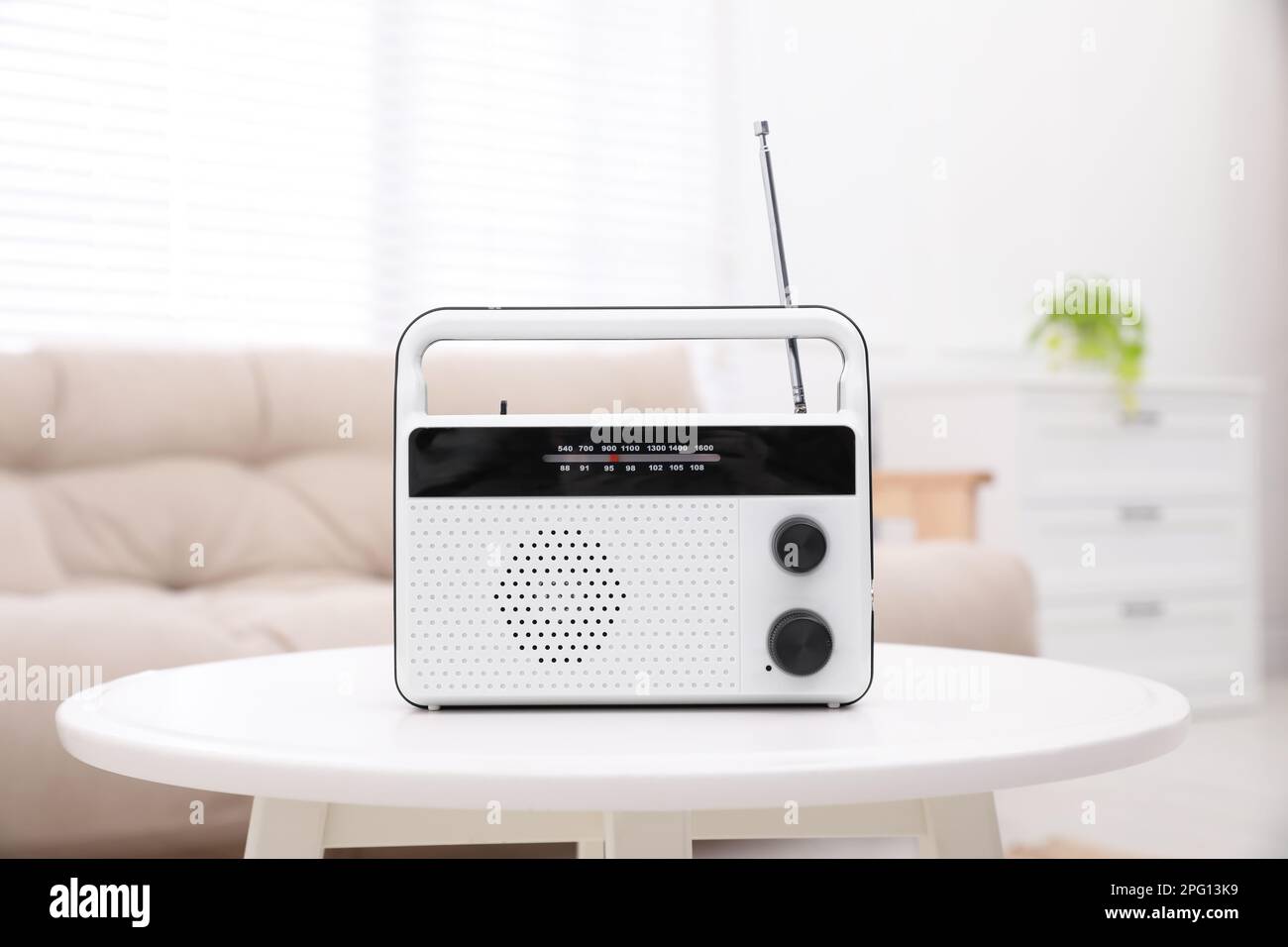 Stylish white radio on table in living room Stock Photo - Alamy