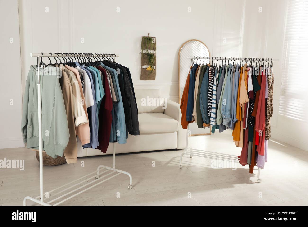 Racks with stylish clothes indoors. Fast fashion Stock Photo - Alamy
