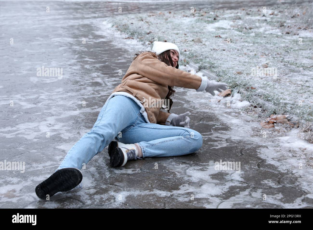 Young woman fallen on slippery icy pavement outdoors Stock Photo - Alamy