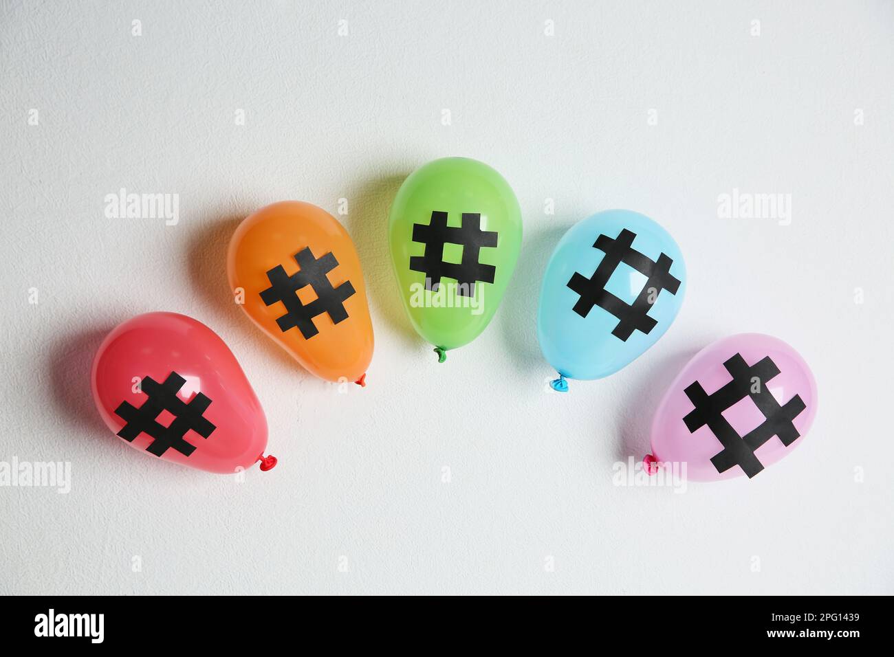 Bright balloons with hashtag symbols on white background Stock Photo ...