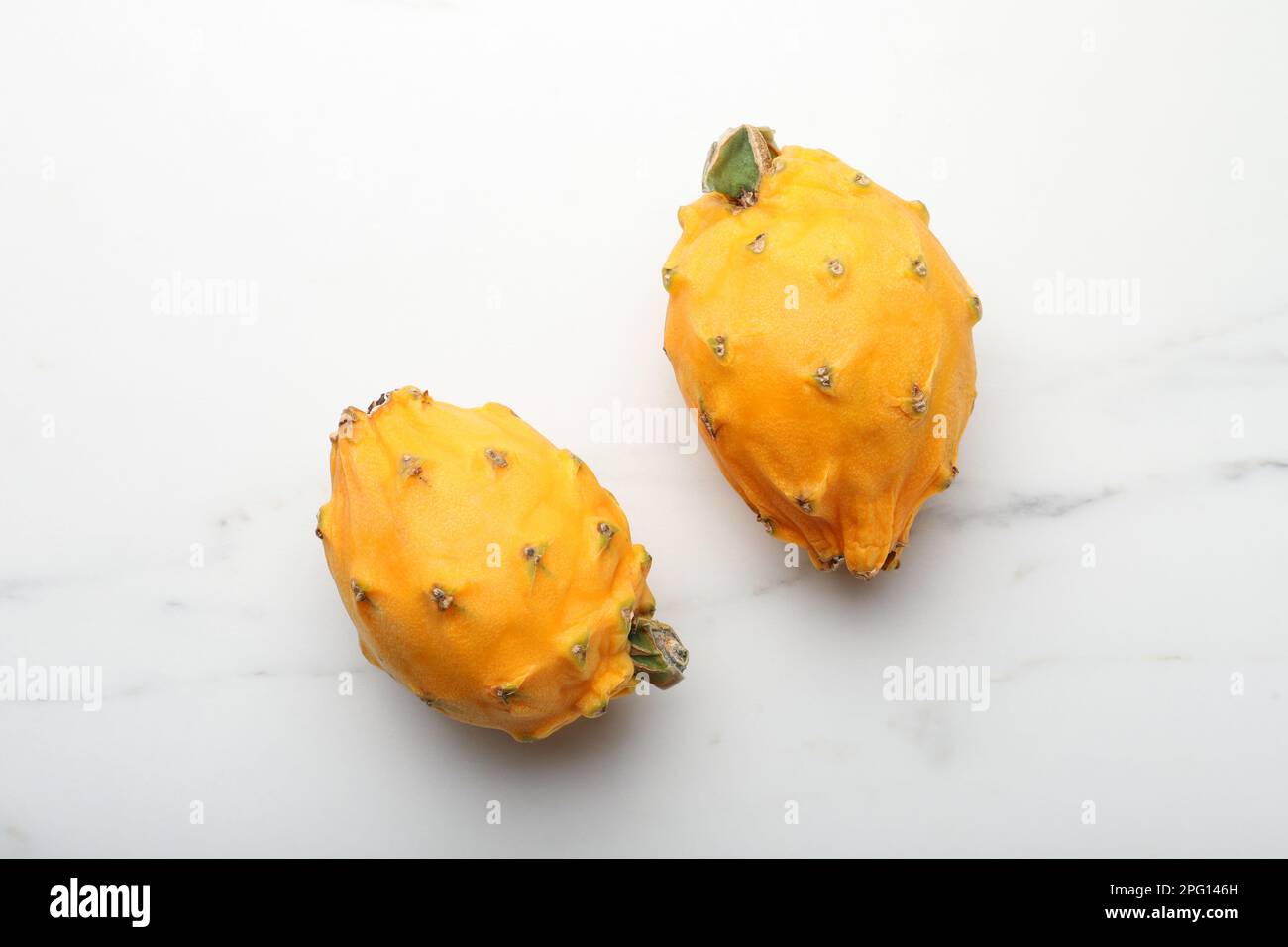 Delicious yellow pitahaya fruits on white marble table, flay lay Stock ...