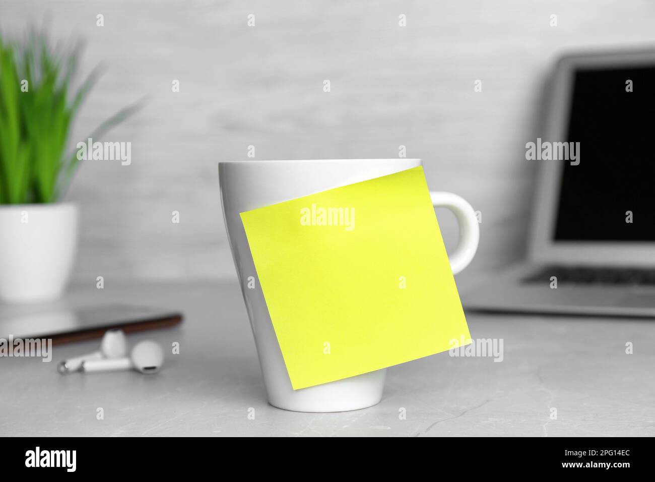 Cup with blank sticky note on white office table. Space for text Stock ...