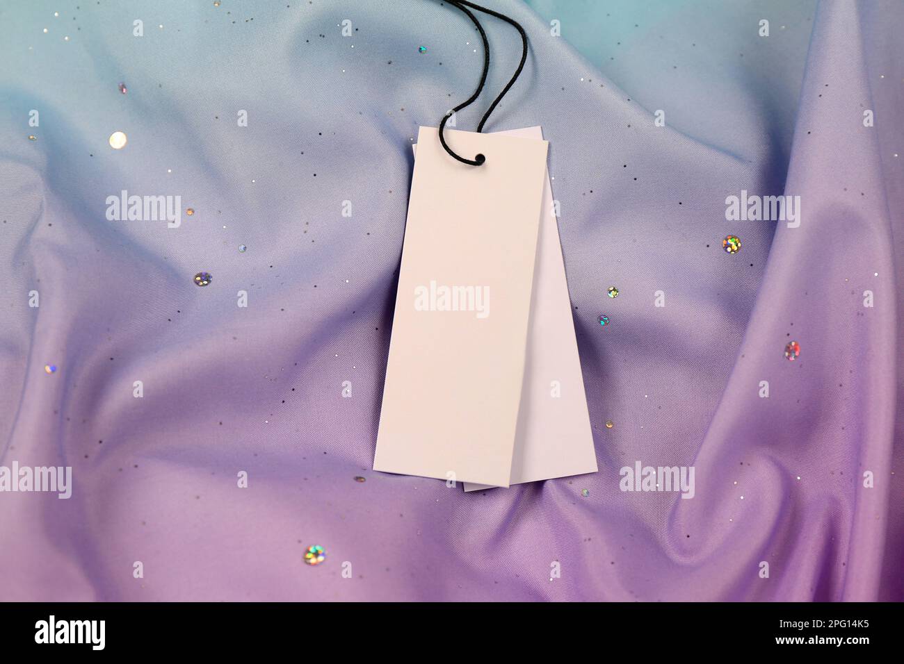 Blank white tags on color fabric, top view. Space for text Stock Photo ...