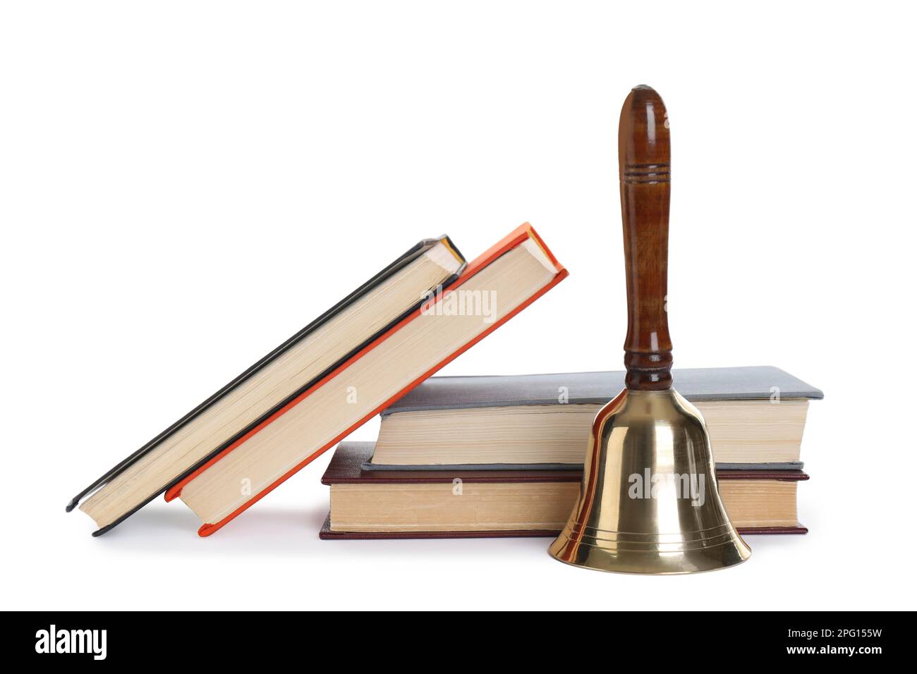 Golden school bell with wooden handle and books on white background ...