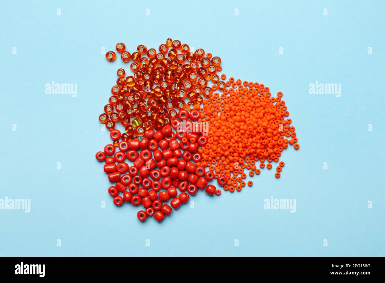 Pile of different beads on light blue background, flat lay Stock Photo ...