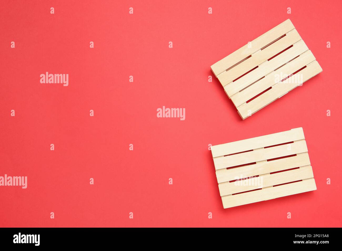 Wooden pallets on red background, flat lay. Space for text Stock Photo ...