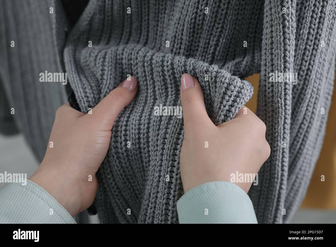 Woman touching clothes made of soft knitted fabric, closeup Stock Photo ...