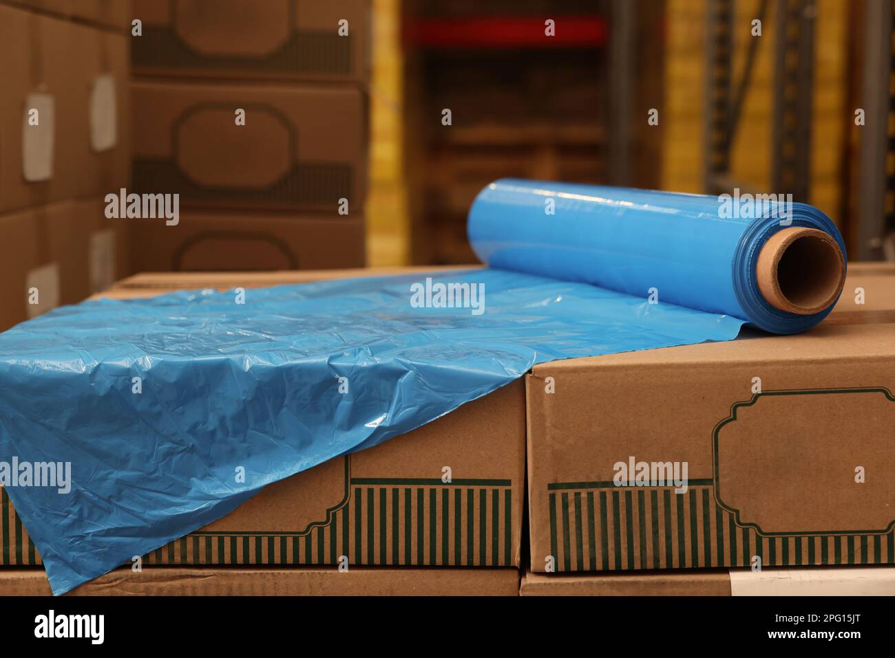 Roll of stretch wrap on boxes in warehouse Stock Photo - Alamy