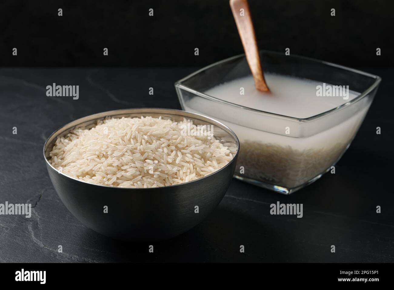 Rice soaked in water on black table Stock Photo - Alamy