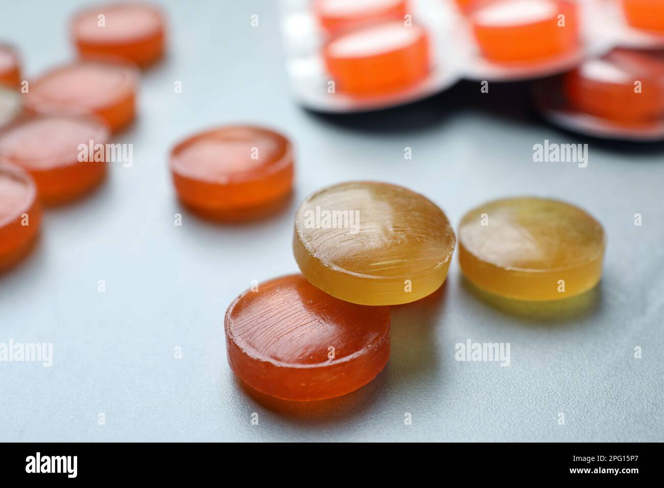 Colorful cough drops on grey background, closeup. Space for text Stock ...