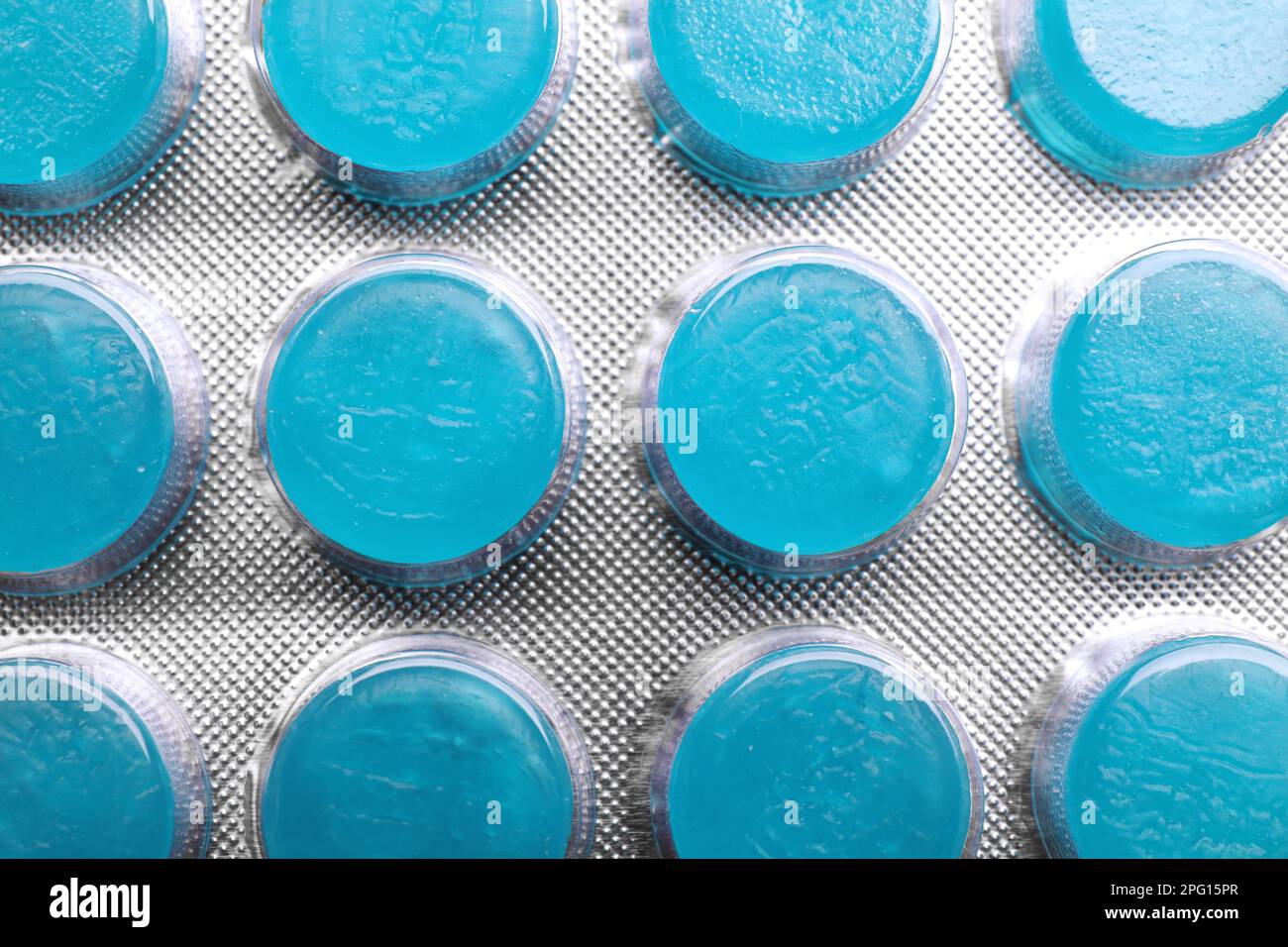 Blister with blue cough drops as background, closeup Stock Photo - Alamy
