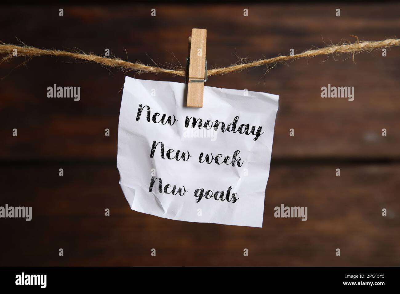 New Monday, New Week, New Goals - motivational quote. Crumpled paper note with text against ...