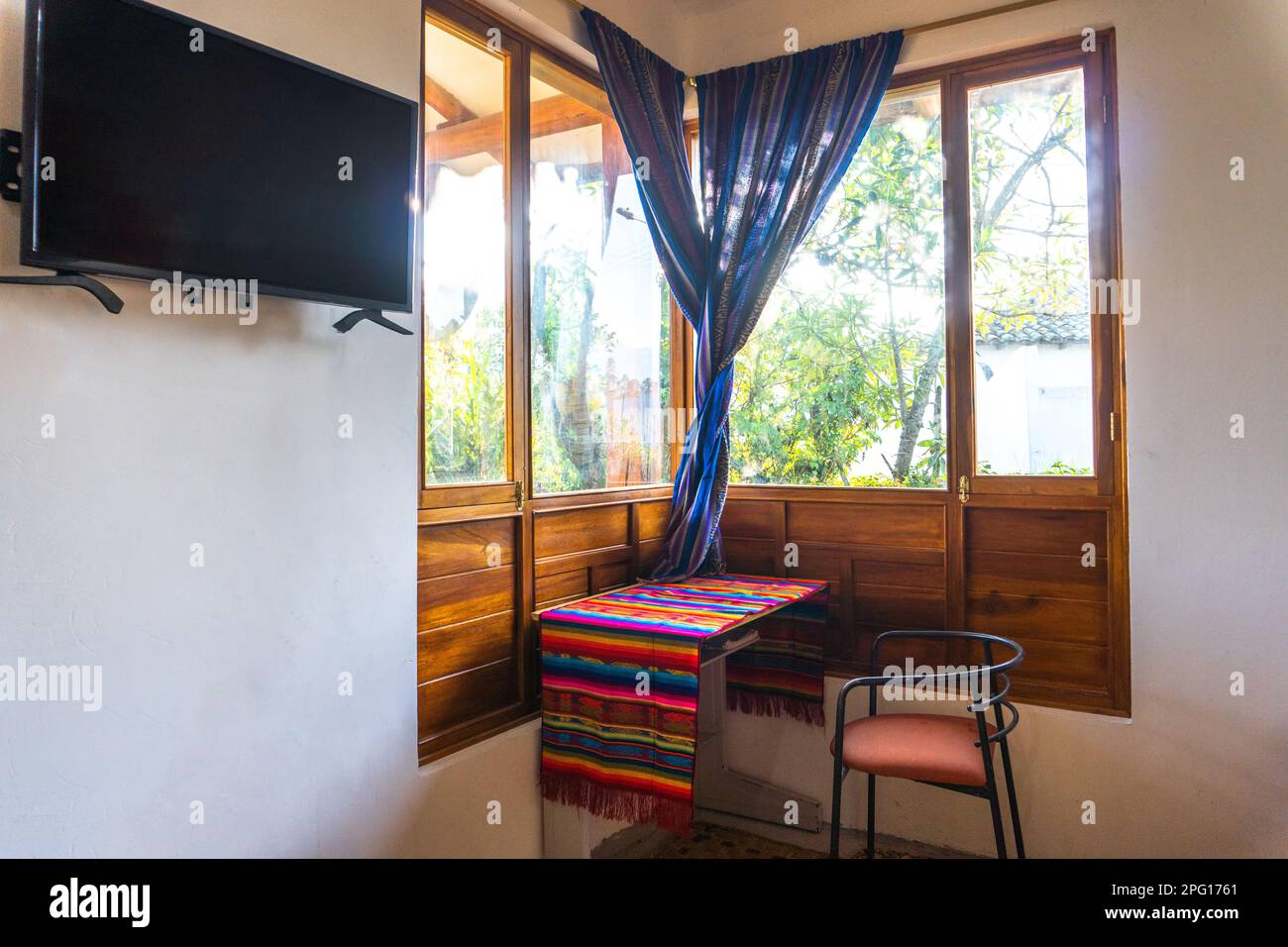 workspace in a cottage next to a window with a desk and a plasma TV ...