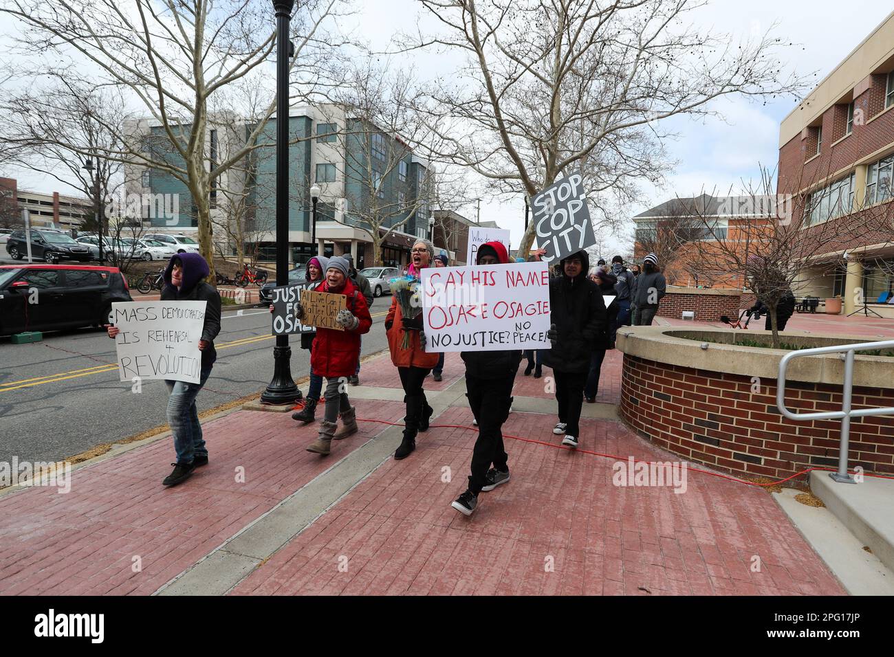 State College, United States. 19th Mar, 2023. People hold placards as ...