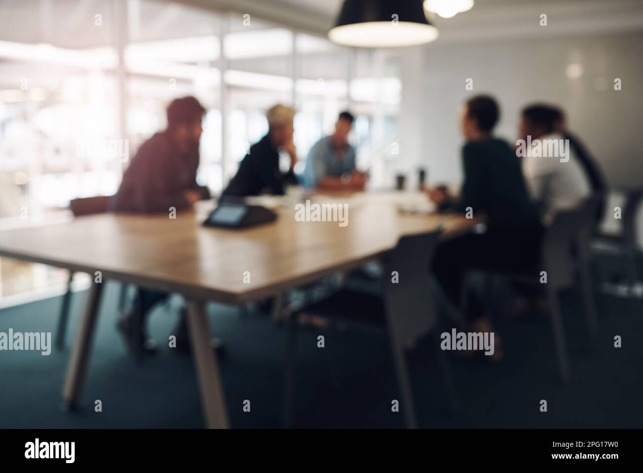 Meeting in session. a group of business colleagues sitting around a ...