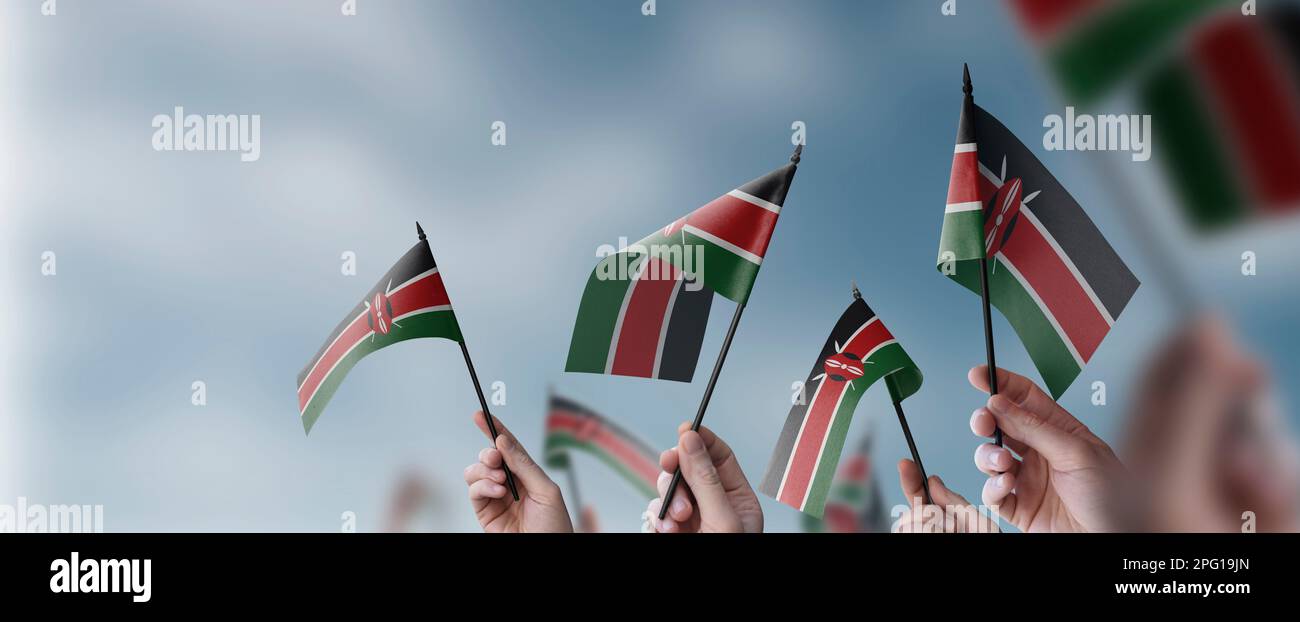 A group of people holding small flags of the Kenya in their hands Stock ...