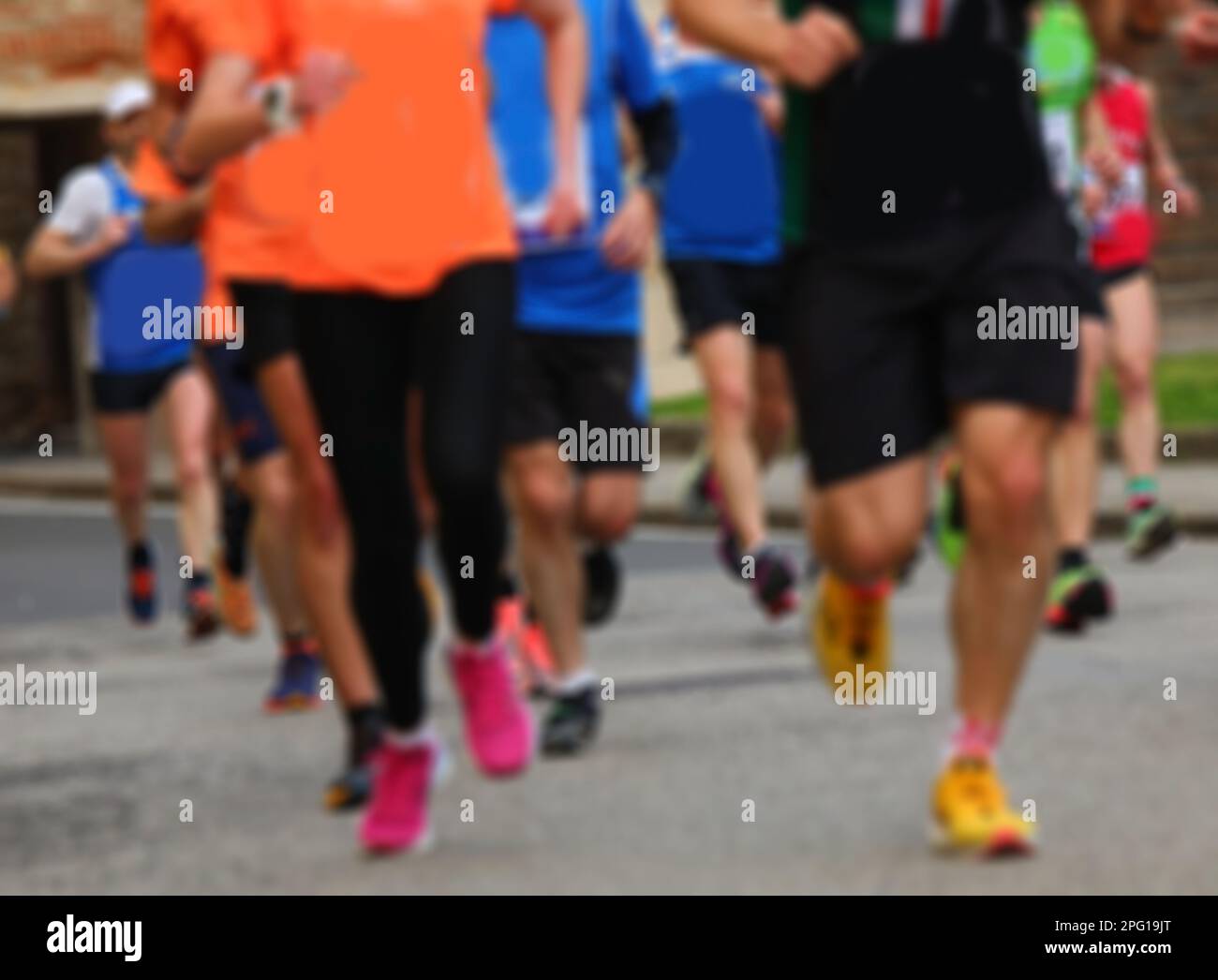 Intentionally blurred group of runners during the ideal running race as ...