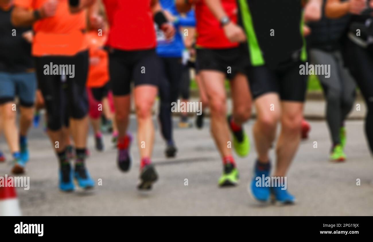 Intentionally blurred group of runners during the ideal running race as ...