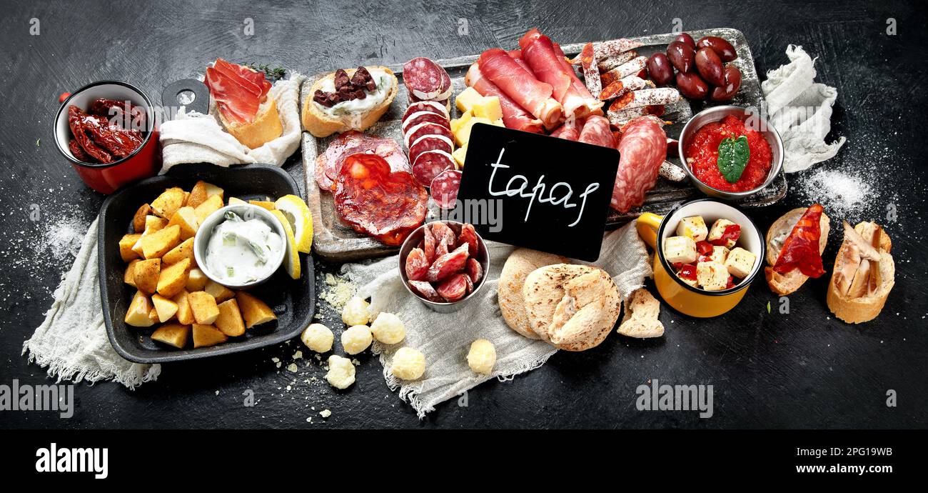 Typical spanish tapas with jamon slices, chorizo, salami, olives ...