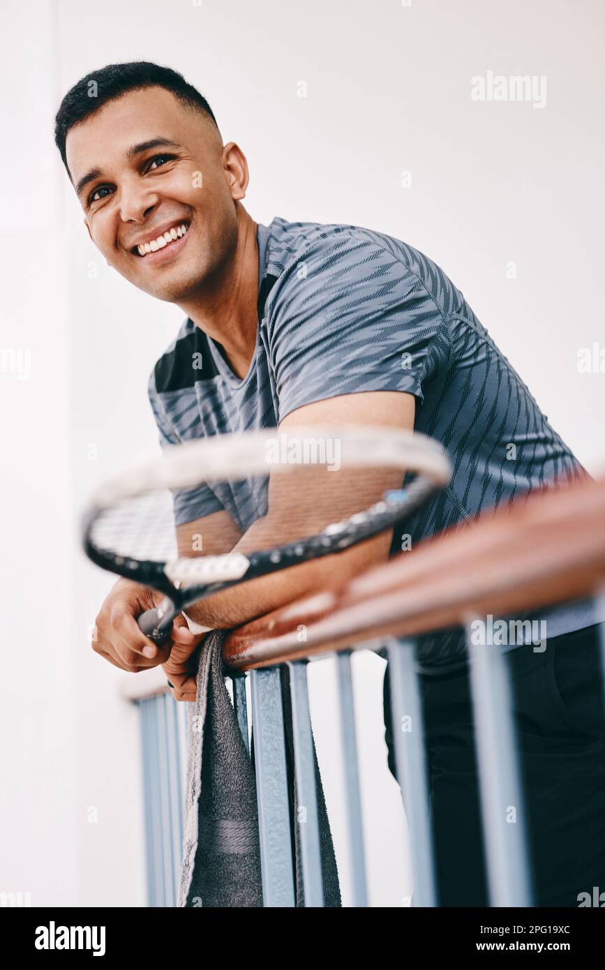 Did someone say squash. a young man watching a game of squash from the ...