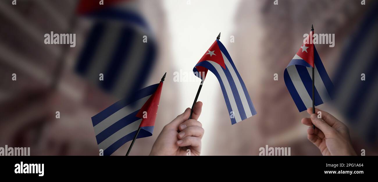 A group of people holding small flags of the Cuba in their hands Stock ...