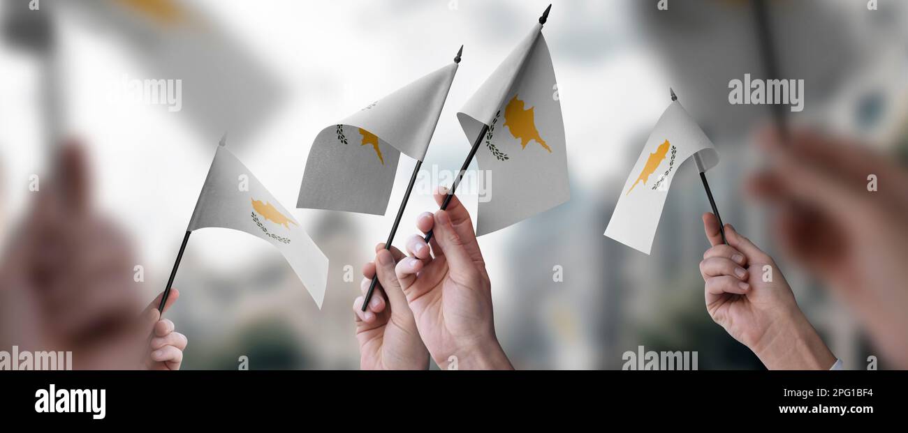 A group of people holding small flags of the Cyprus in their hands ...