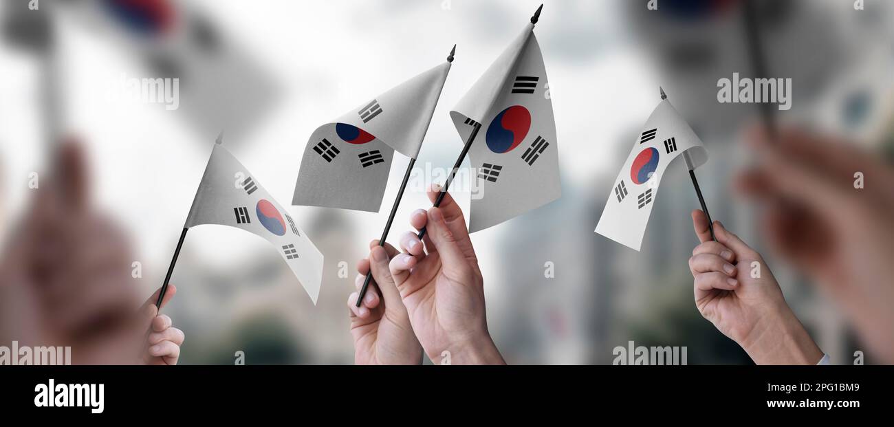 A group of people holding small flags of the South Korean in their ...