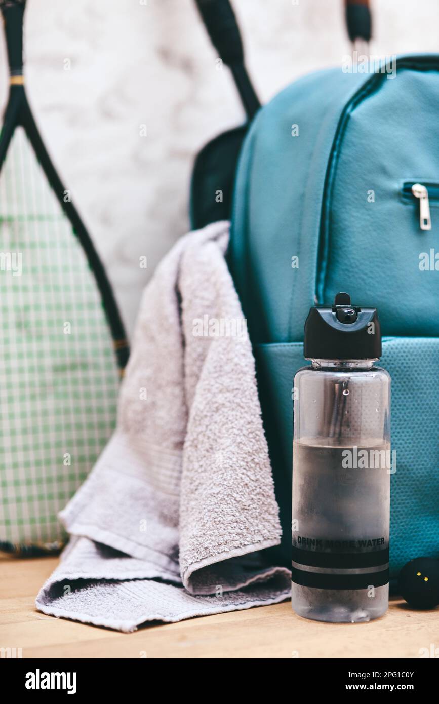 Gear that the squash gods use. a sports bag and other items in an empty ...