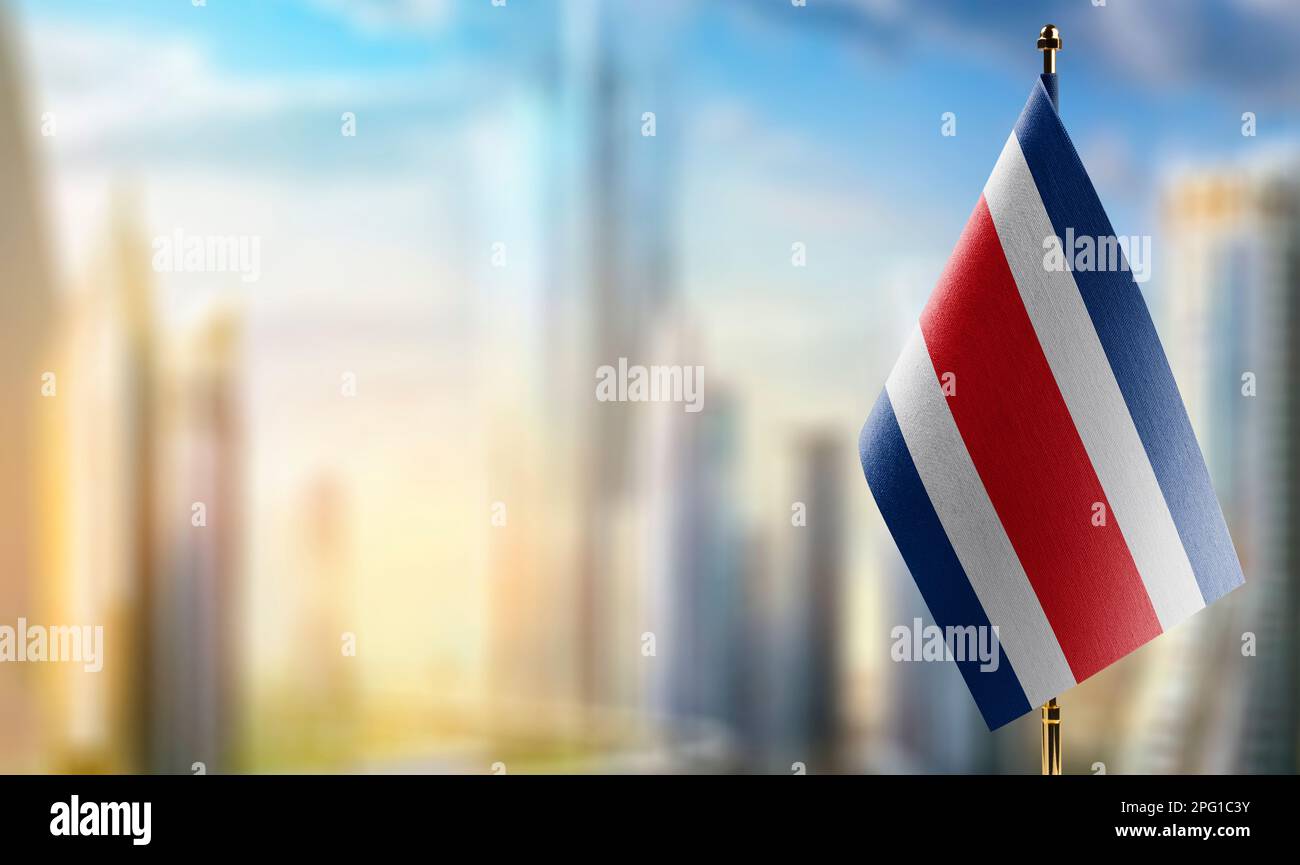 Small flags of the Costa Rica on an abstract blurry background Stock ...