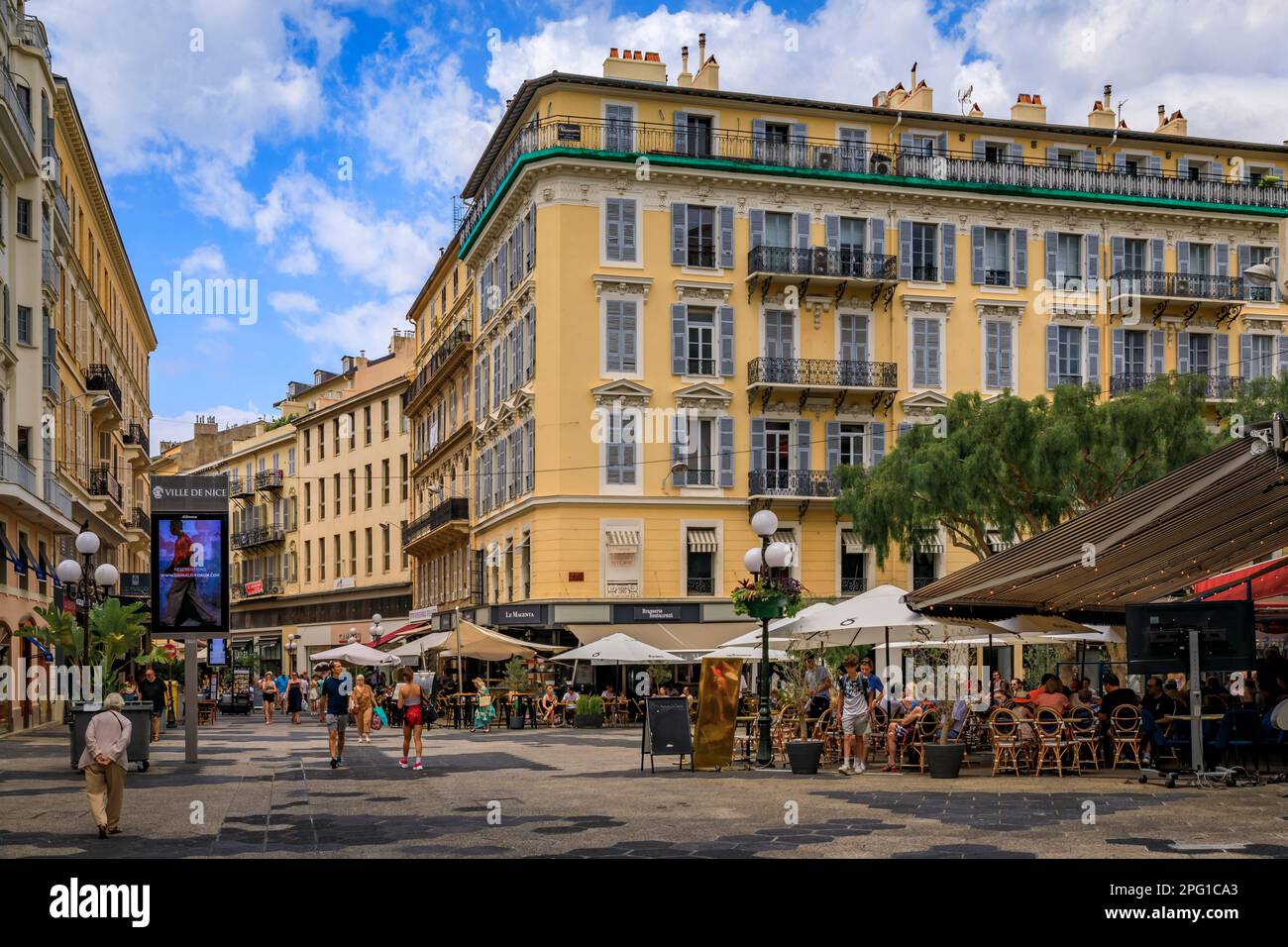 Nice, France - May 29, 2022: Restaurants and bars on a busy square in ...