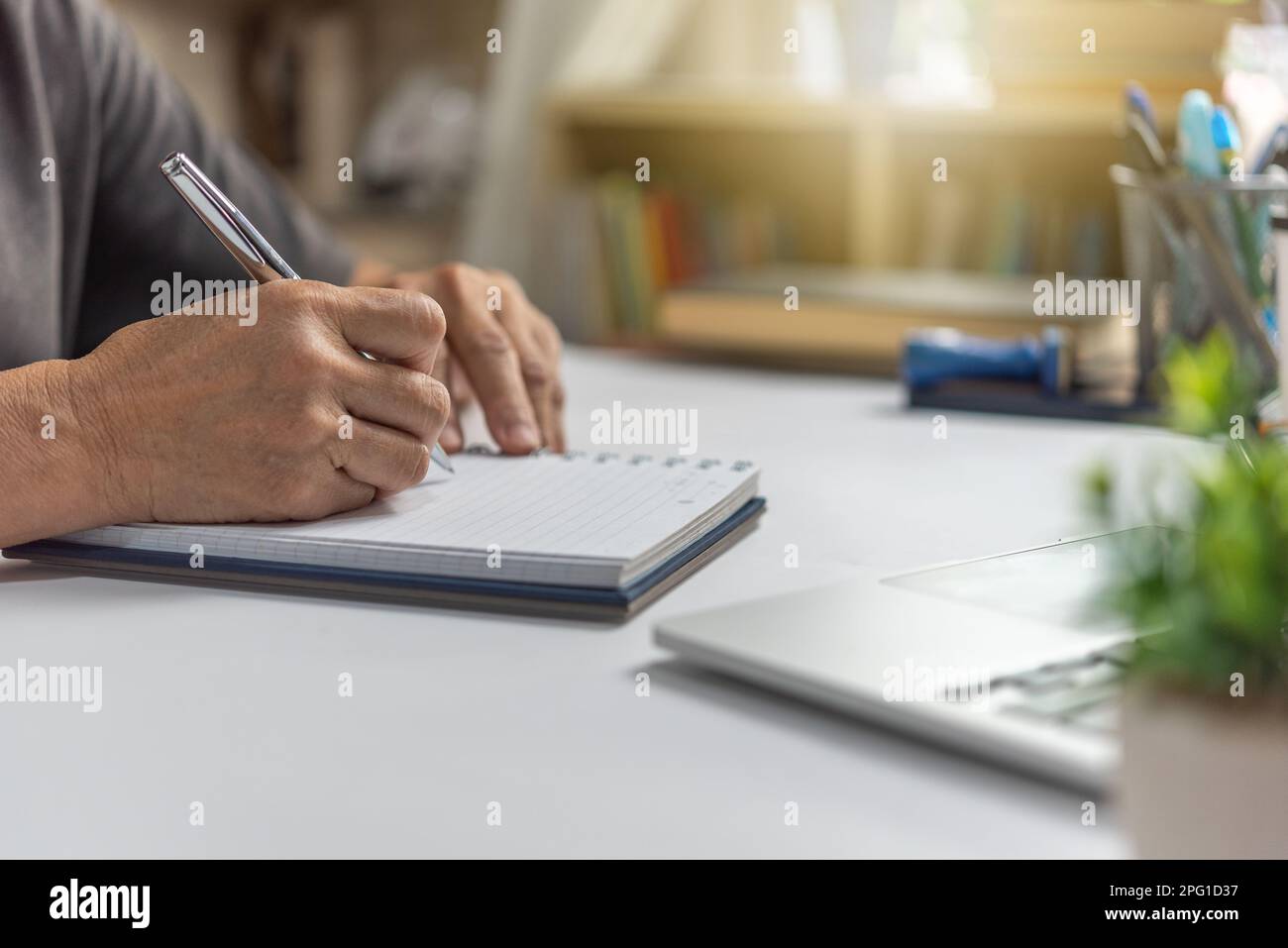 Woman hands with pen writing on notebook in the office.learning ...