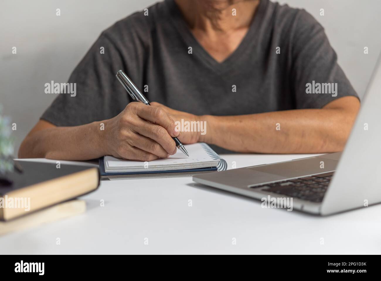 Woman hands with pen writing on notebook in the office.learning ...