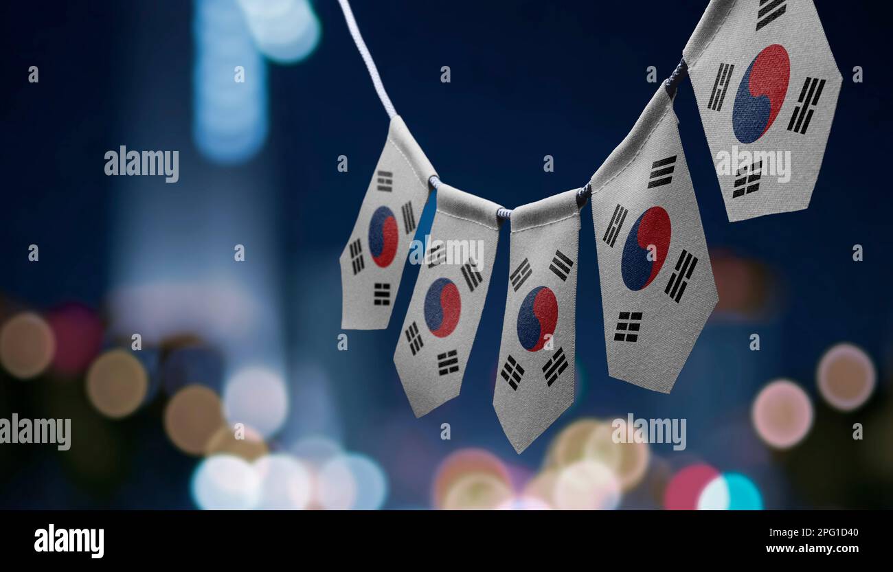 A garland of South Korean national flags on an abstract blurred ...