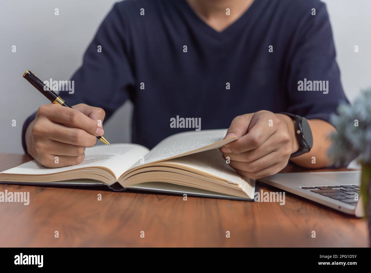 learning online class by using laptop computer and writing notebook at ...