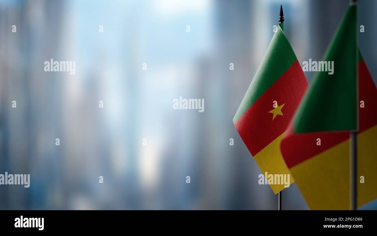 Small flags of the Cameroon on an abstract blurry background Stock ...